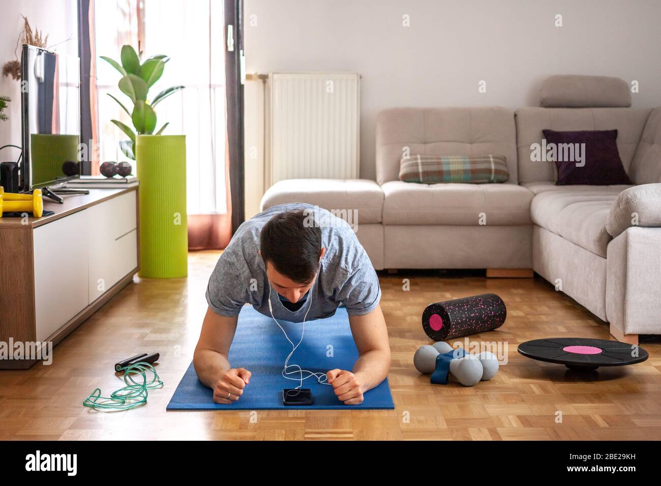 young man exercising doing workout at home in front of laptop Stock ...