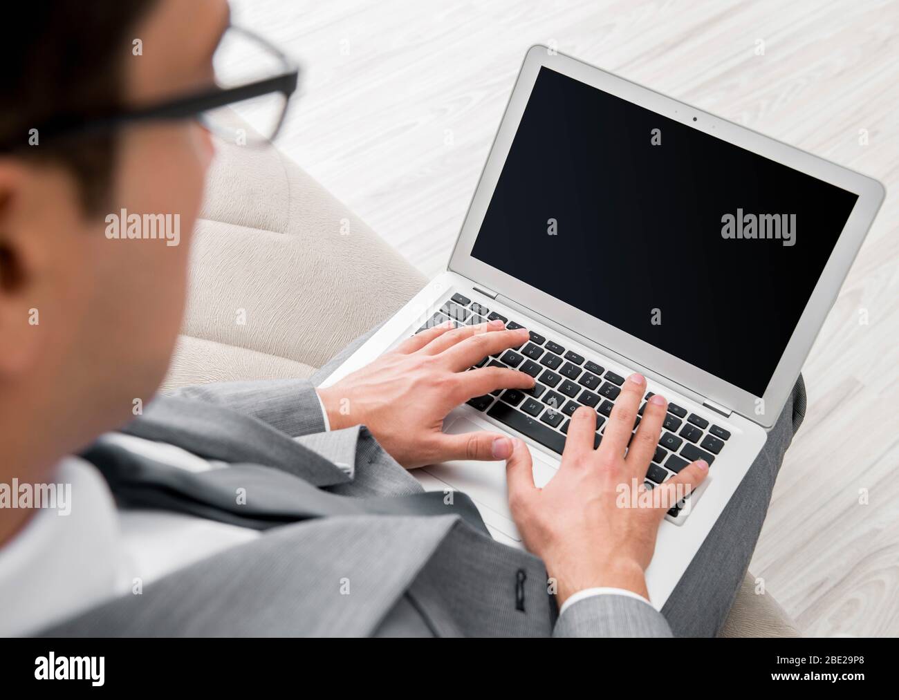 The businessman working with laptop in business concept Stock Photo - Alamy