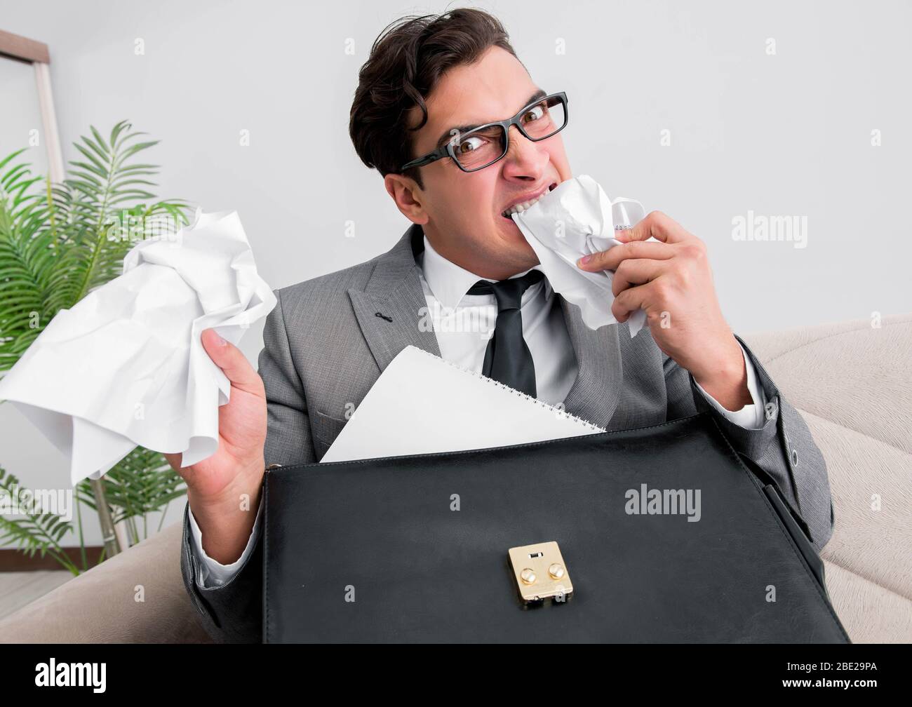 The angry businessman with crumbled paper Stock Photo - Alamy