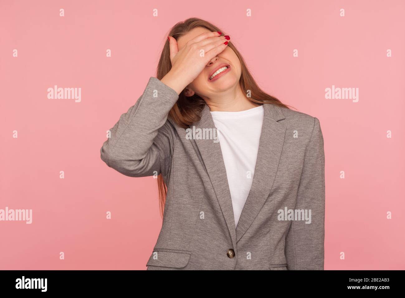 Don't want to look! Portrait of displeased young woman in business suit ...