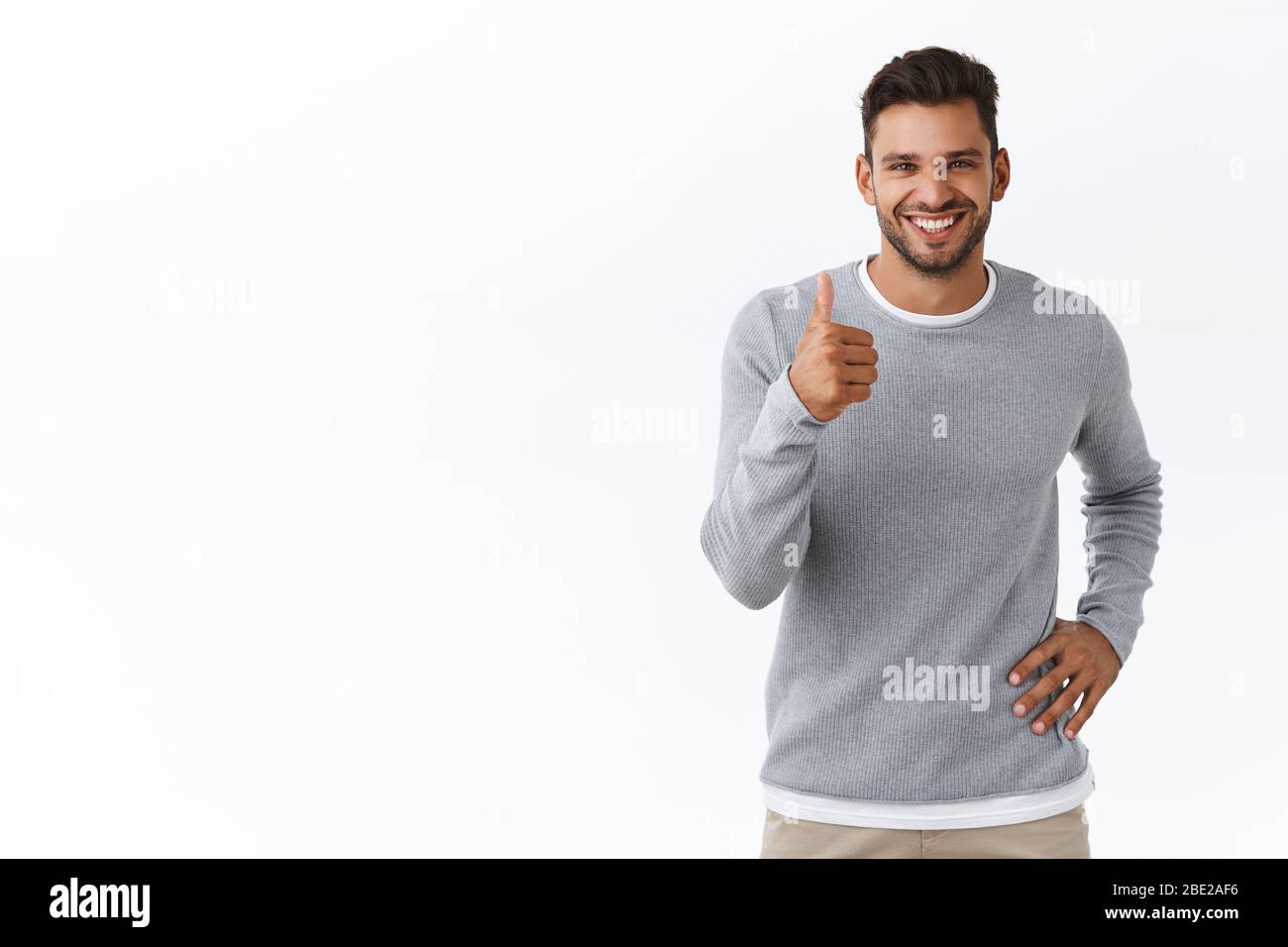 Good job, nicely done. Satisfied smiling handsome young male coworker ...