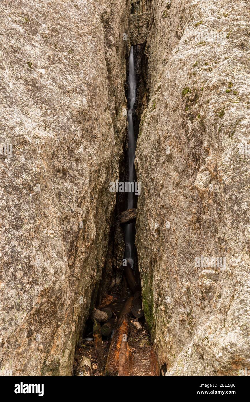 Waterfall Inside A Crack In A Rock Stock Photo - Alamy