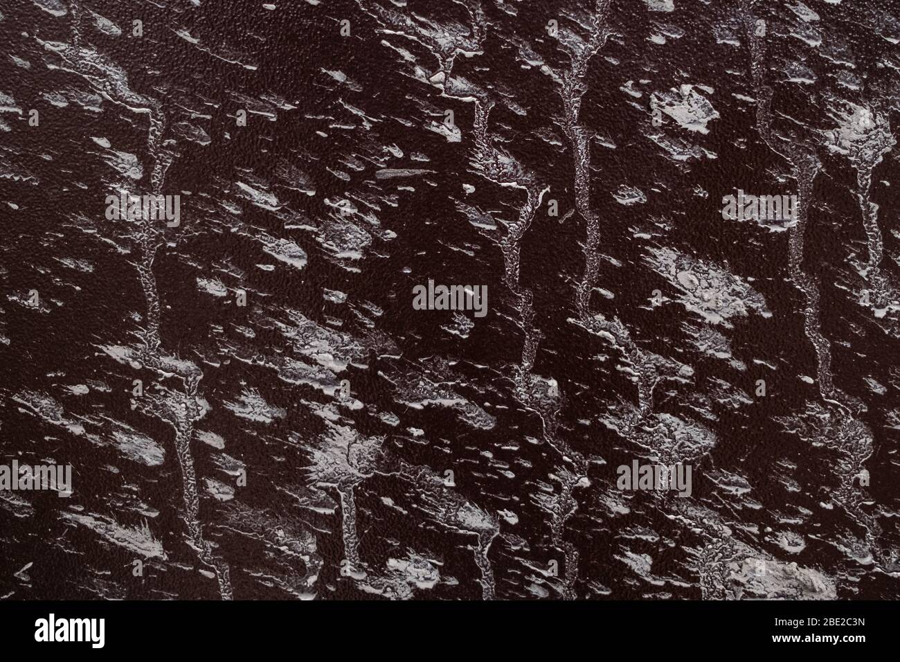 Dark brown metal surface splattered with dirt. A pattern of stains of ...