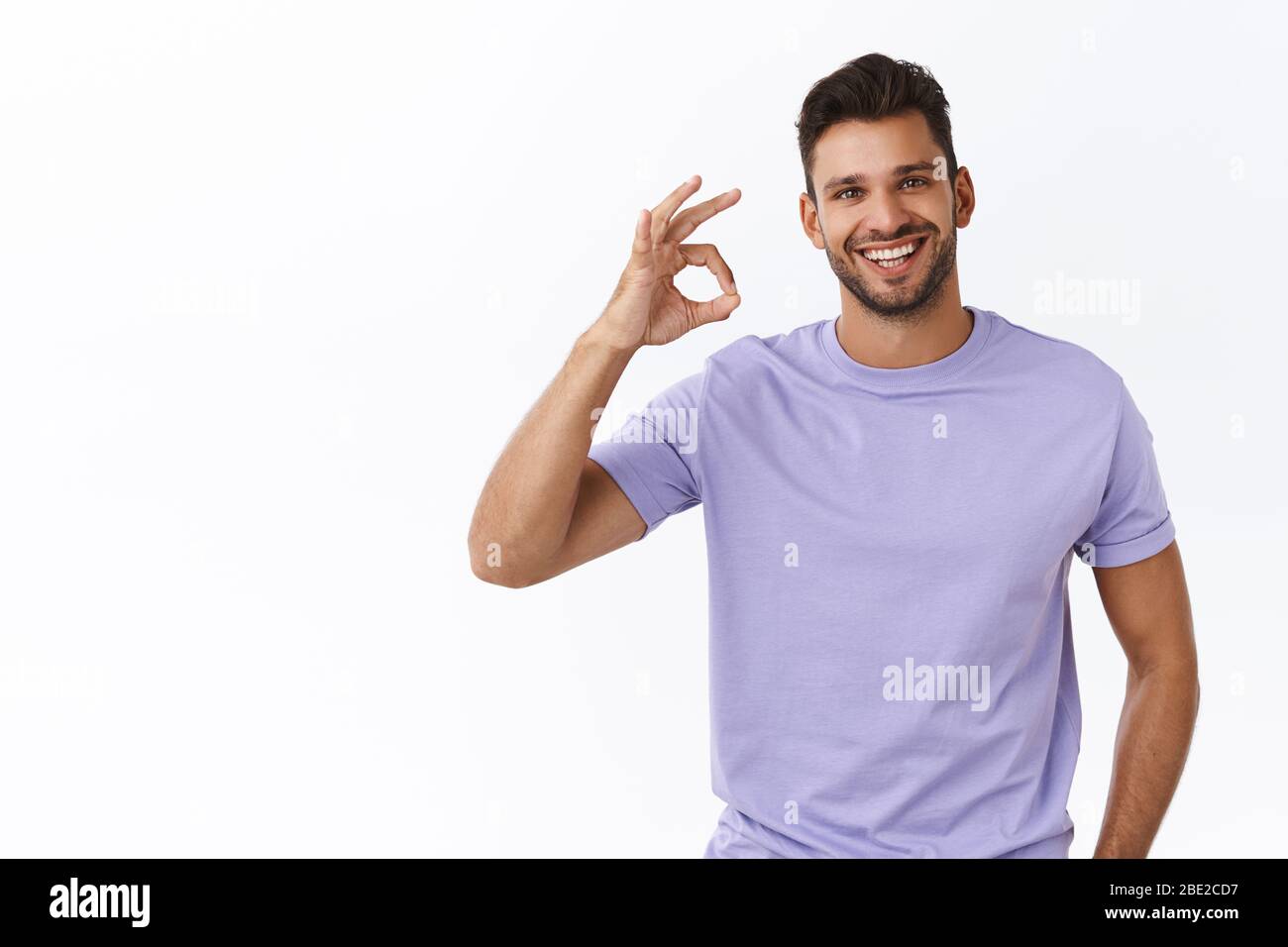 Handsome masculine smiling, encouraged man with bristle, wear purple t ...