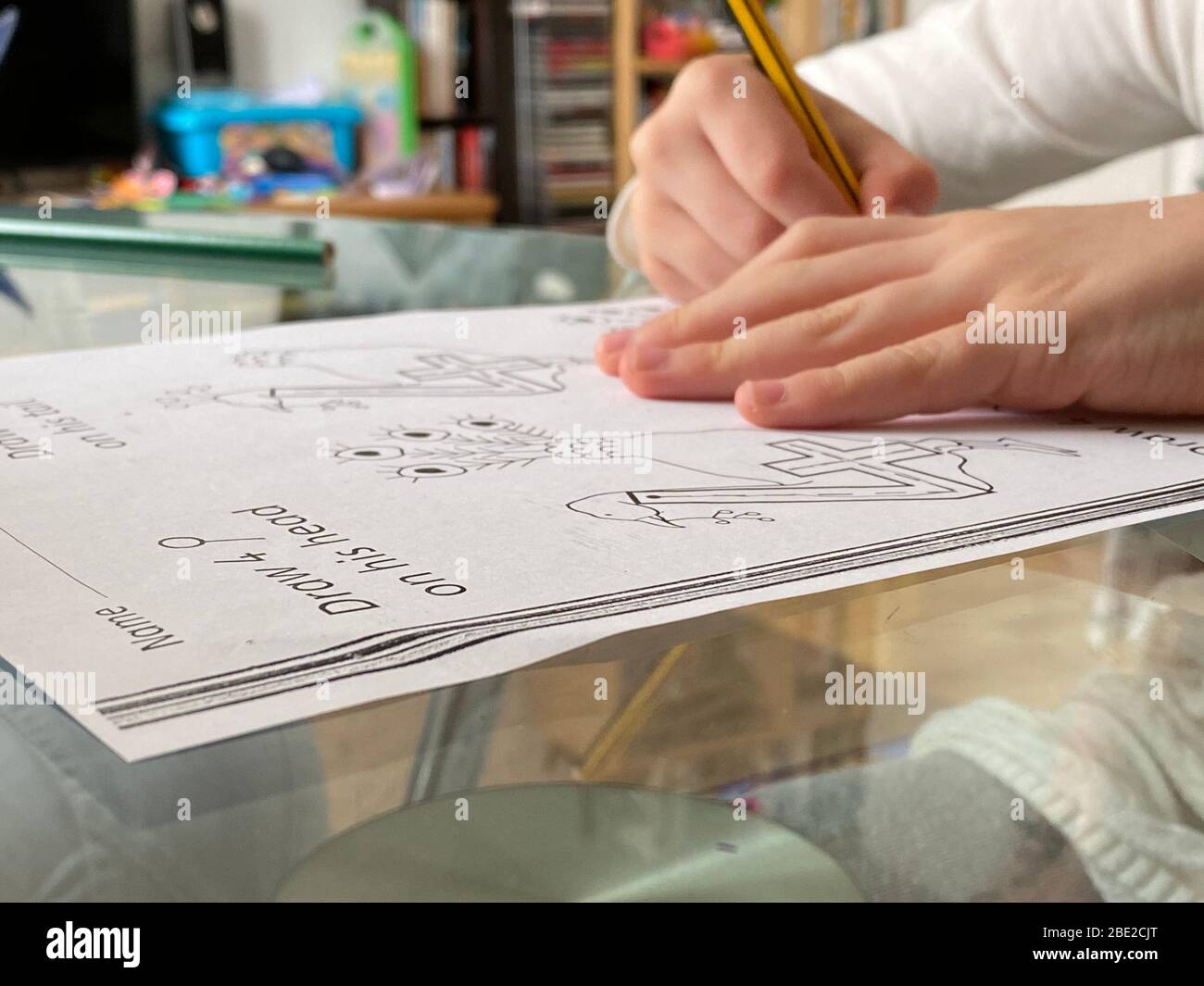 Child hands holding pencil and schoolwork paper at home Stock Photo - Alamy