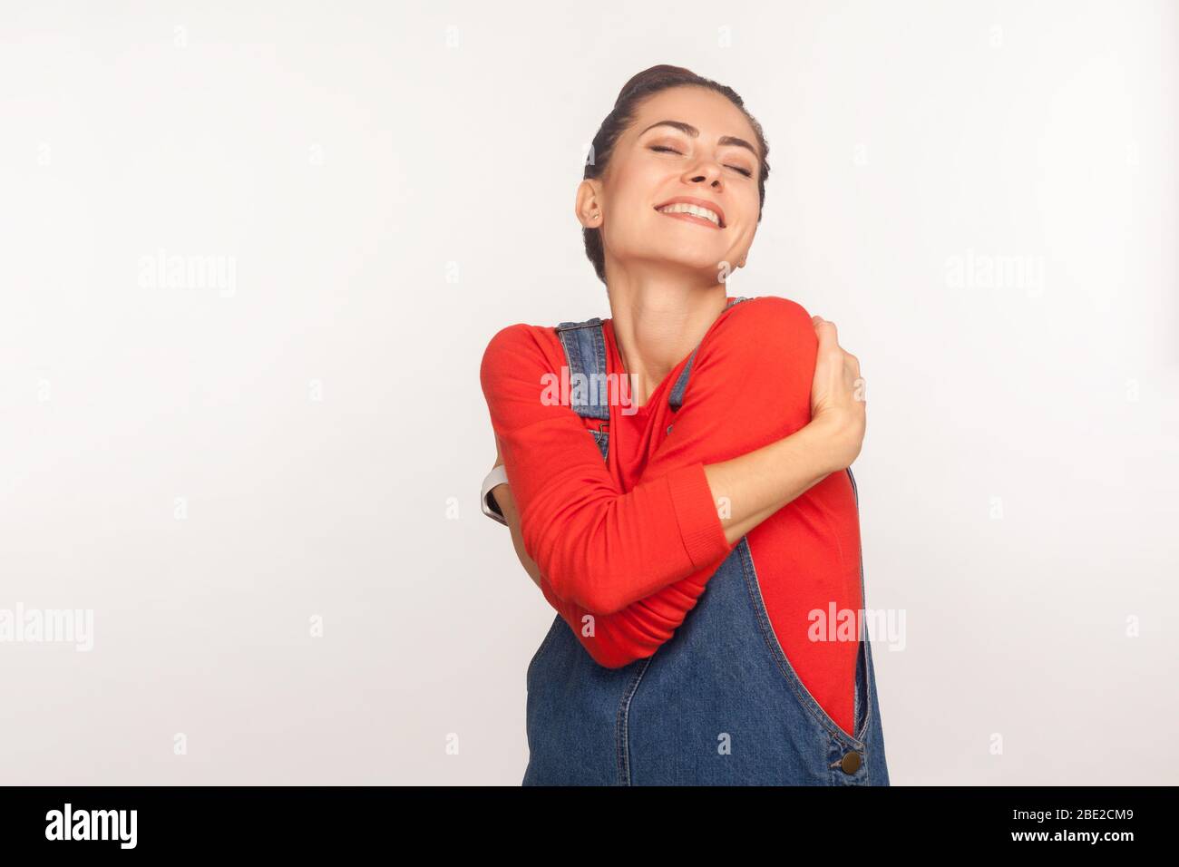 Positive self-esteem. Portrait of stylish girl embracing herself and ...