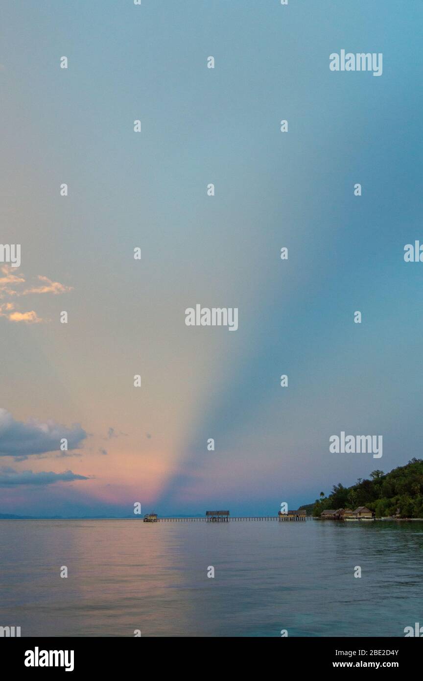 Colorful sky with sunset rays in a tropical island over the sea in Kri ...