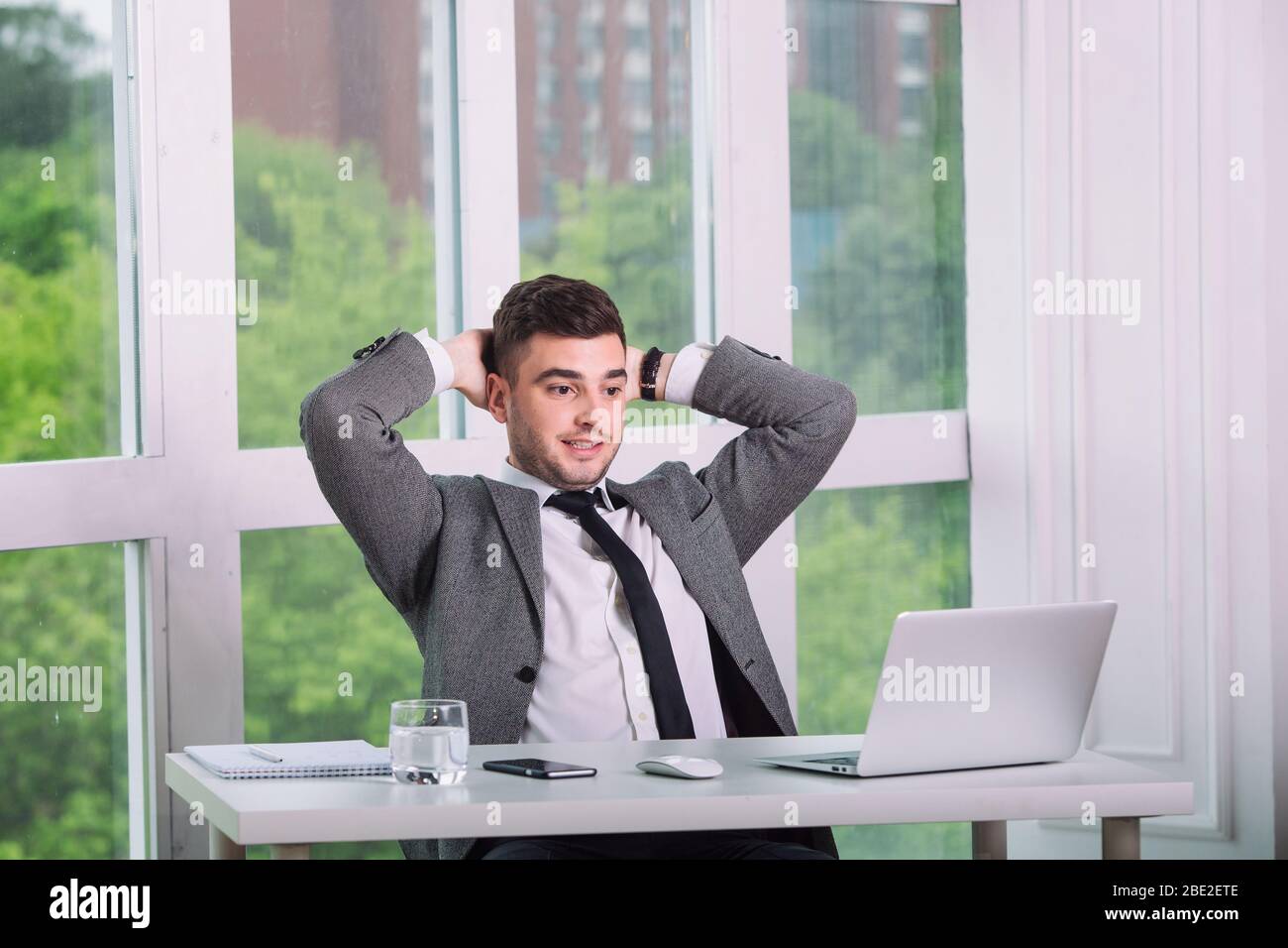 Businessman gets very good news on his computer monitor Stock Photo - Alamy