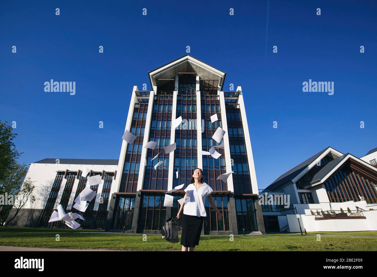 Happy successful businesswoman throwing documents. Paperless work ...