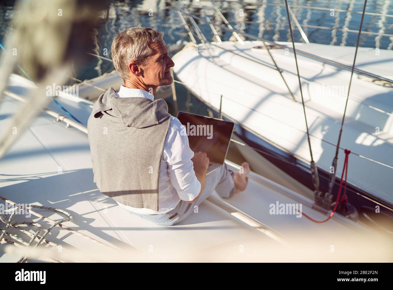 Businessman working computer on boat hi-res stock photography and ...