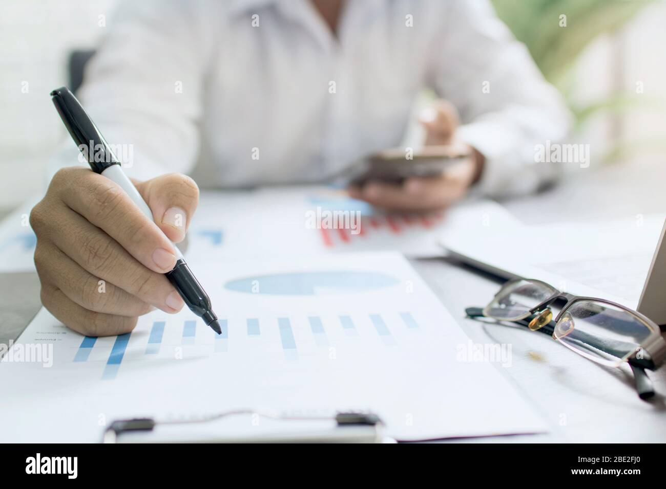 business man or banker checking profit finance graph on table Stock ...