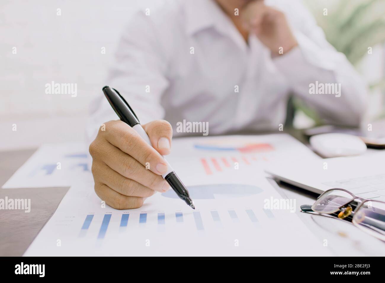 business man checking on financial paper Stock Photo - Alamy
