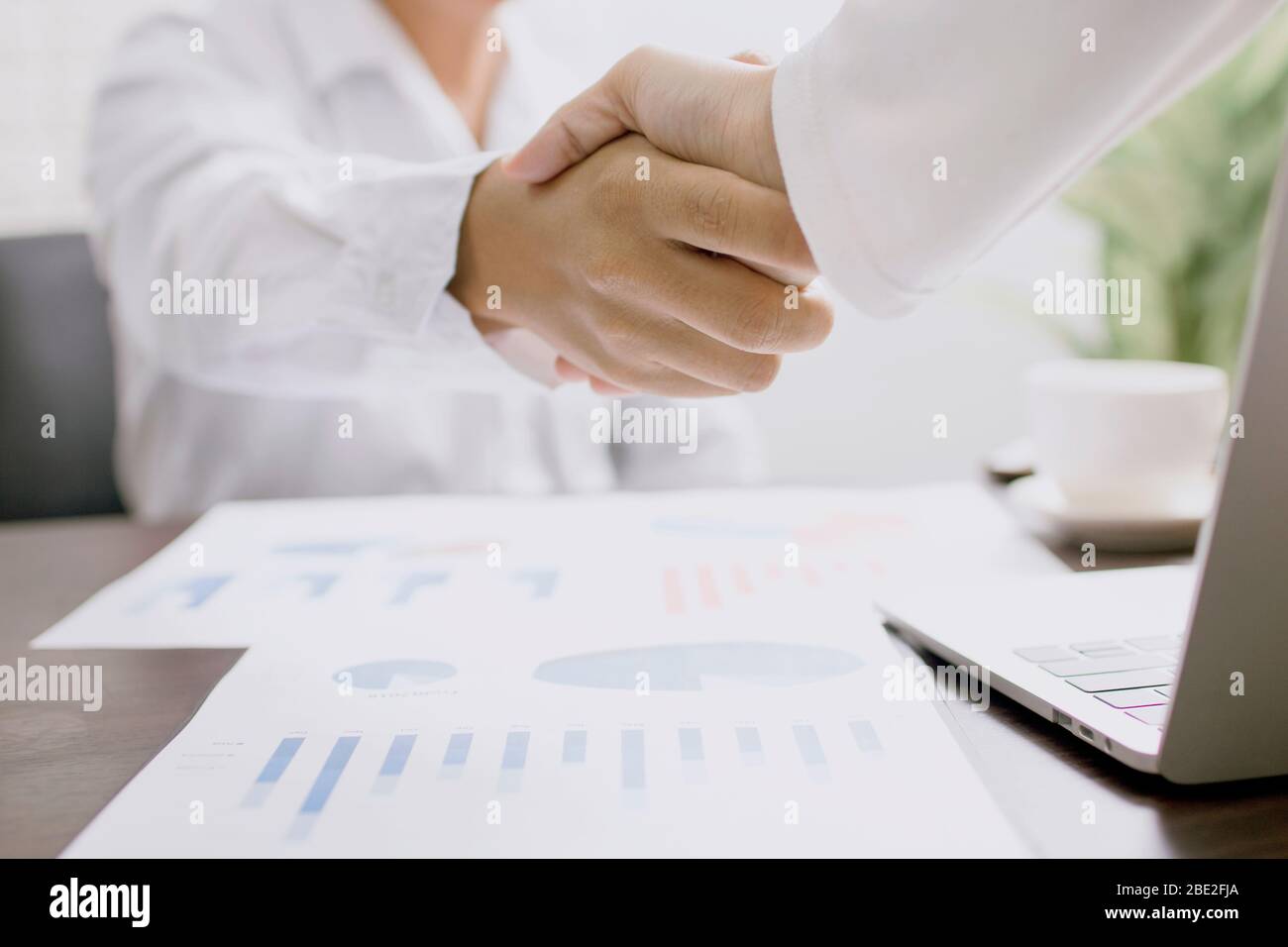 business people shake hands finishing meeting and successful financial ...