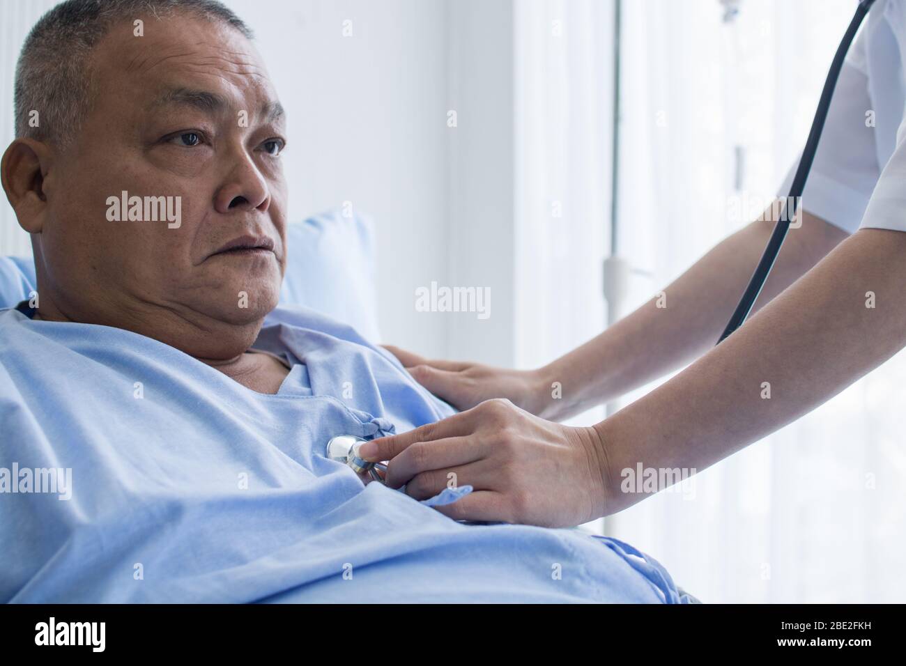 doctor pulse check with medical stethoscope on chest of old patient ...