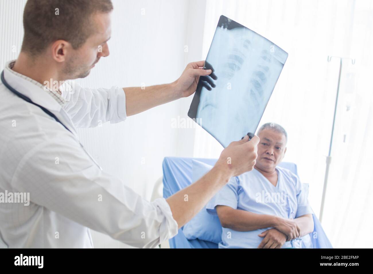 Doctor look at X-ray film and basic diagnosis tuberculosis of old ...