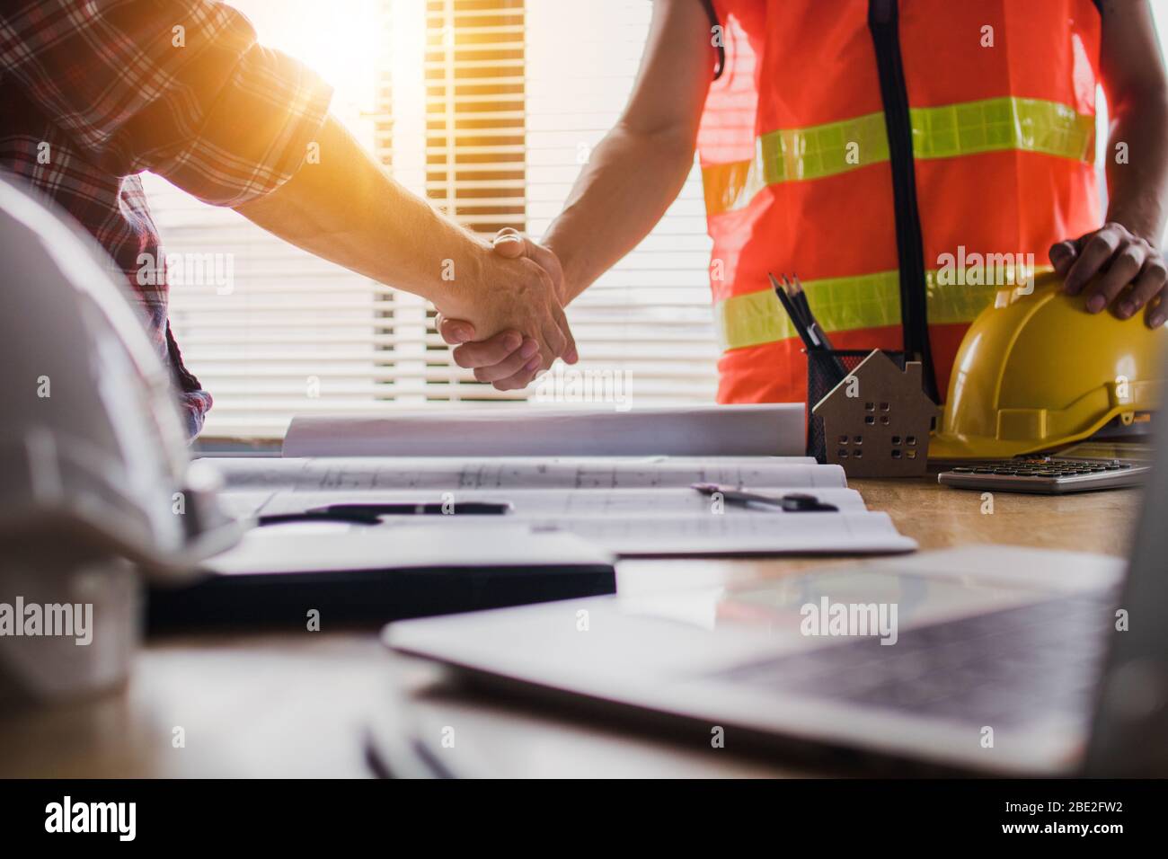 Handshake of two business man, after architect working and planning ...