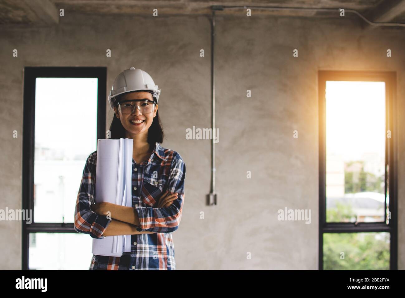portrait of engineering women at construction site with worker working ...