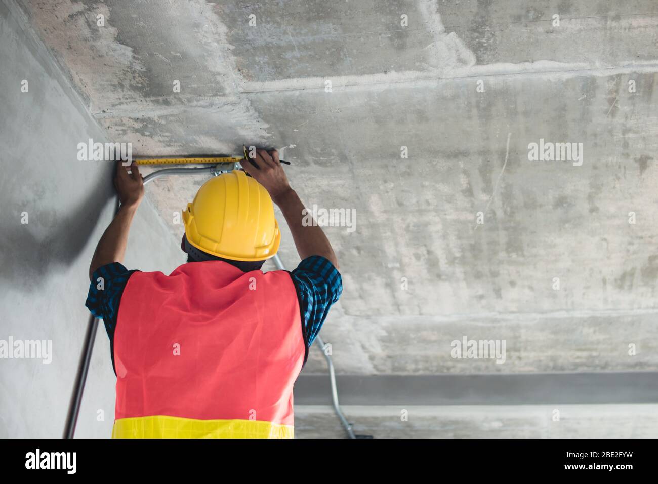 inspector checking and measuring tape measure in building Stock Photo ...