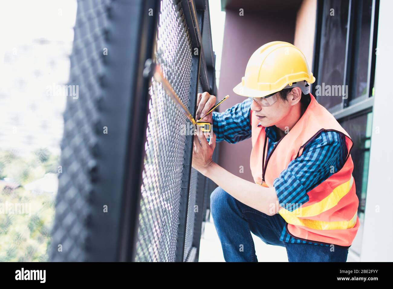 inspector checking and measuring tape measure in building Stock Photo ...