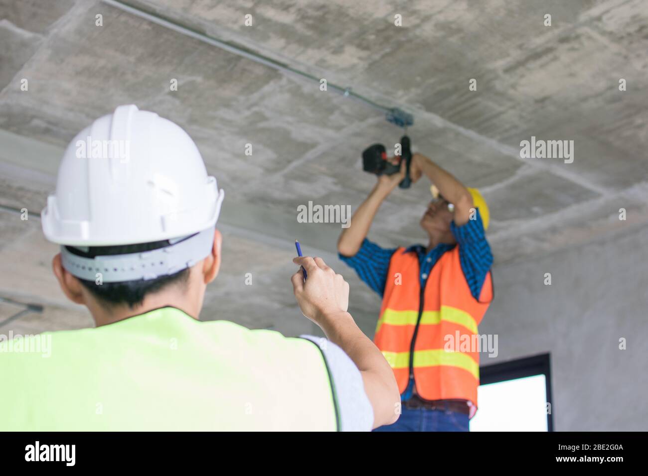 inspector worker working and checking on paper, inspecting build in ...
