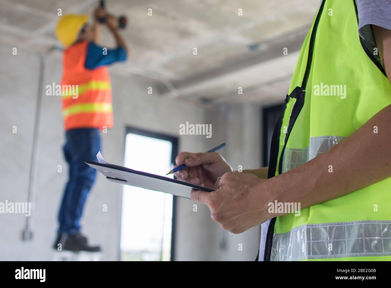 inspector worker working and checking on paper, inspecting build in ...