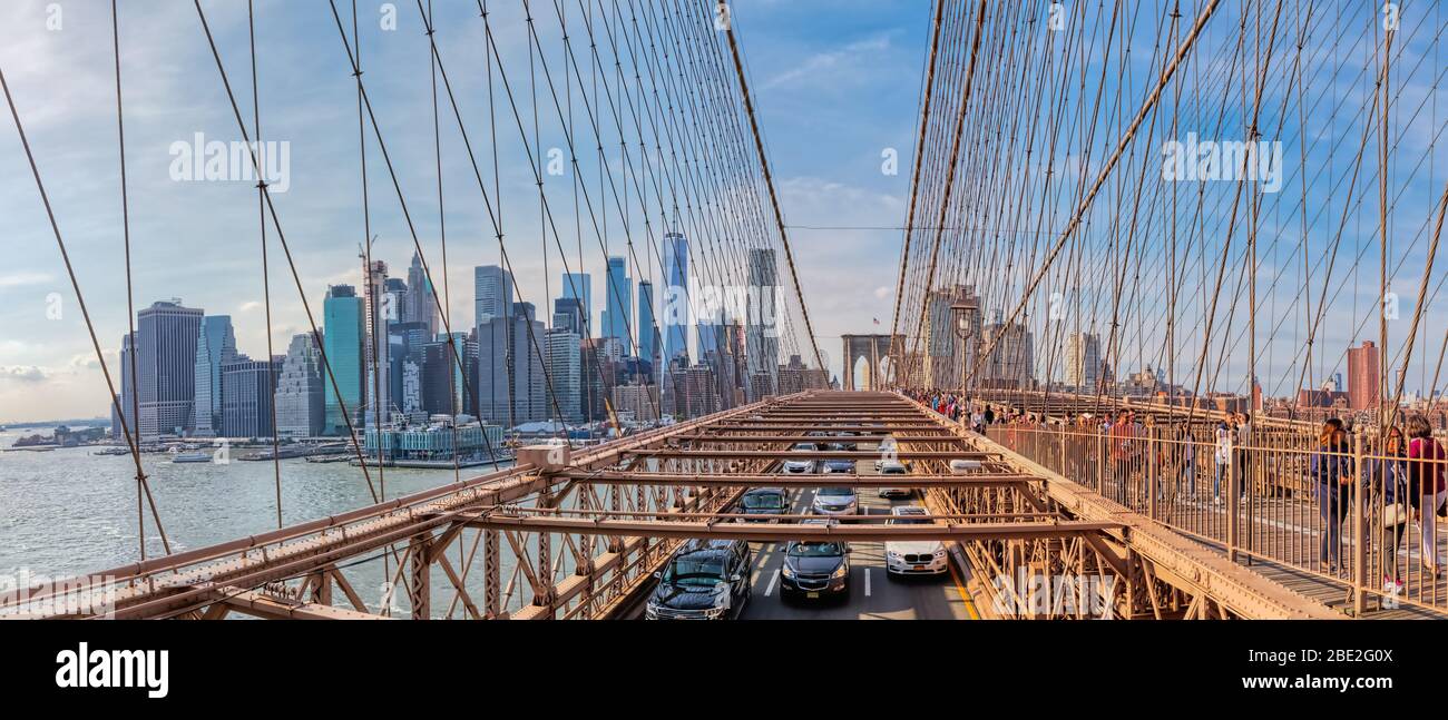 Manhattan through the Brooklyn Bridge cables in New York Stock Photo ...