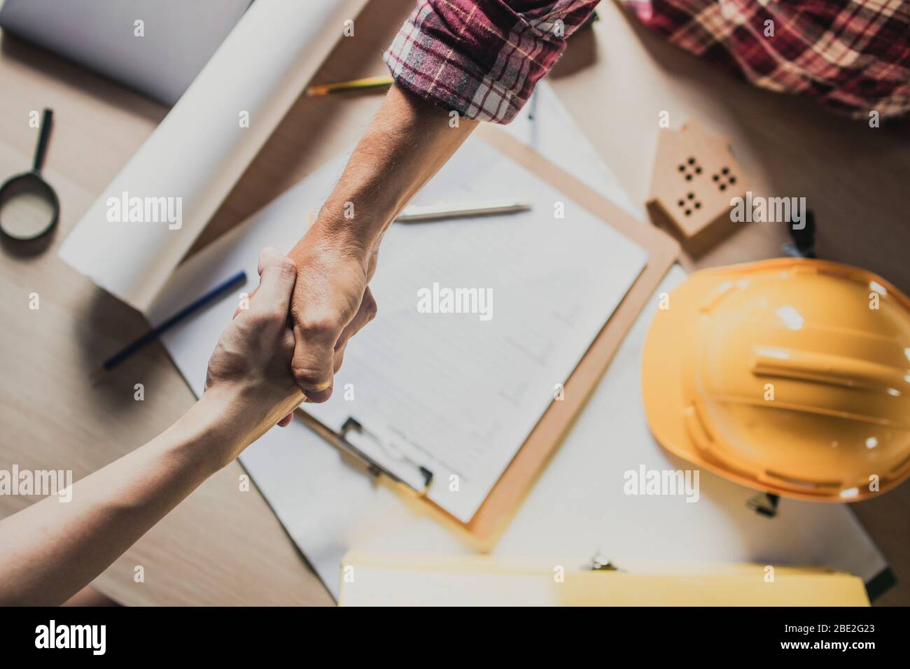 top view hand shake of engineer and building contractor on table Stock ...