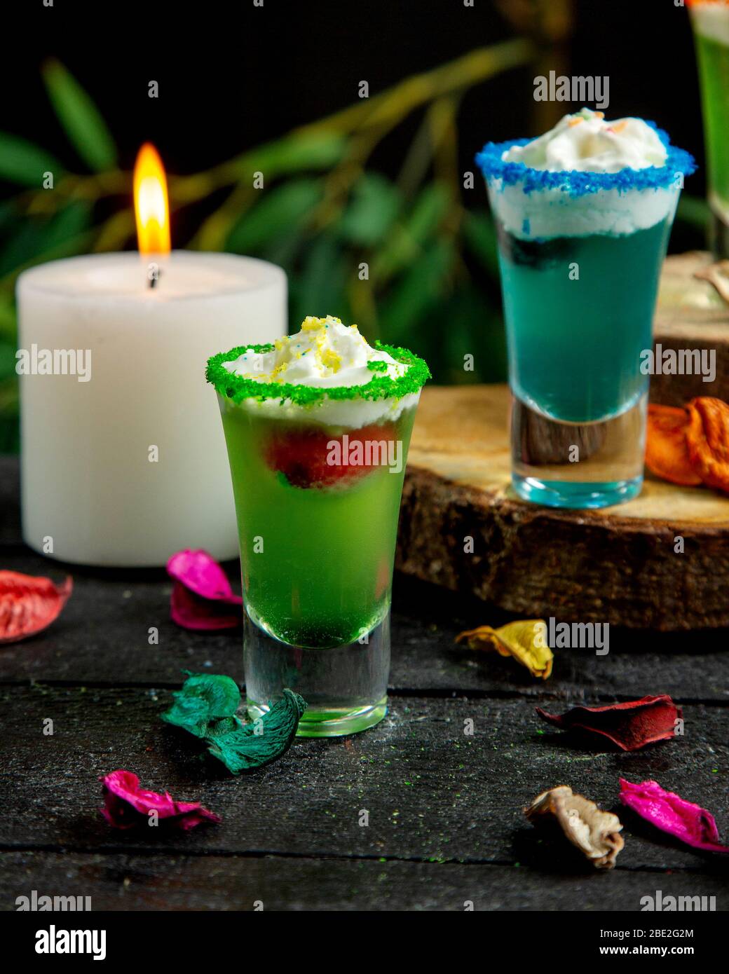 green cocktail shot with strawberry and whipped cream Stock Photo - Alamy