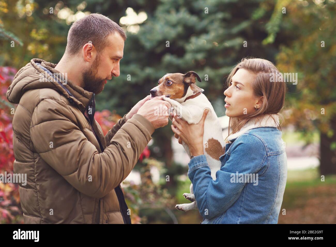 Romantic happy couple in love enjoying their time with pets. Loving ...