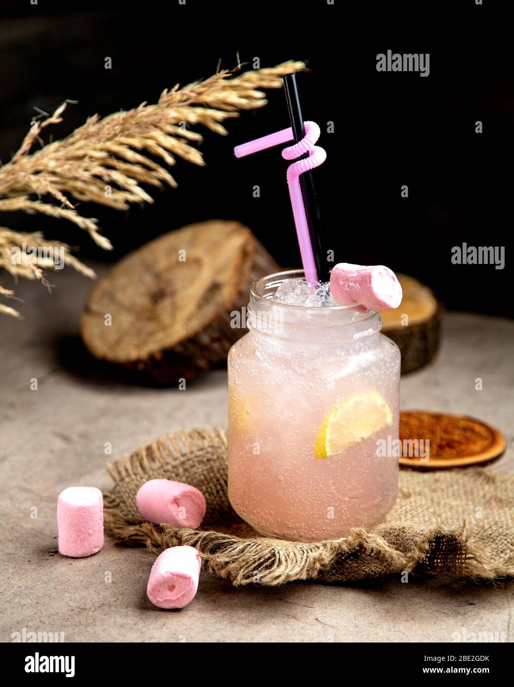 light pink fizzy drink with lemon slice garnished with marshmellow ...