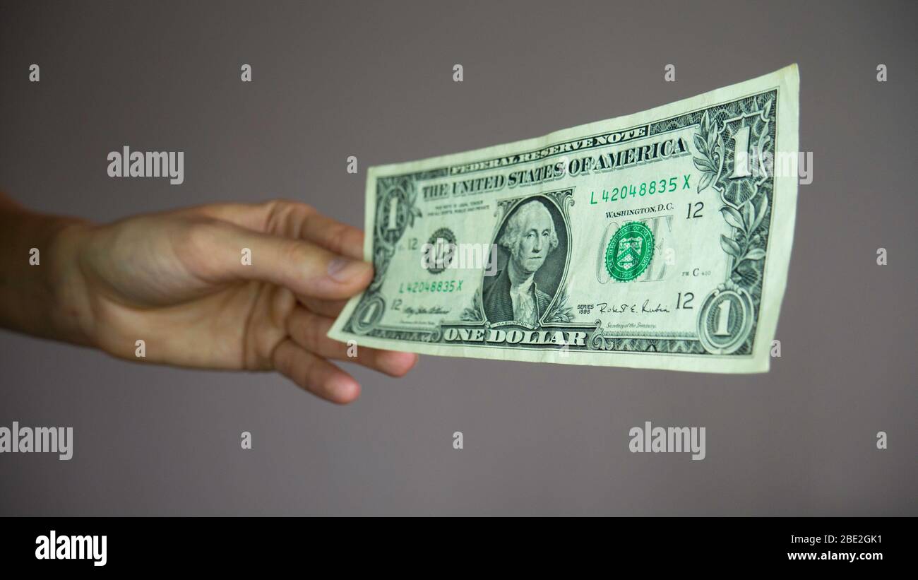 One US dollar in hand. One dollar bill. George Washington Stock Photo ...