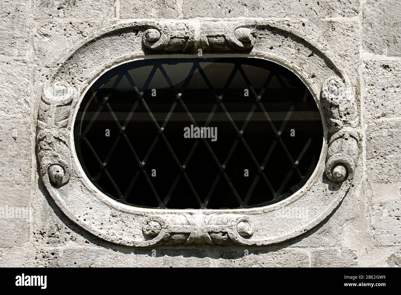 Old an ancient round stone window on very old house in Perast ...