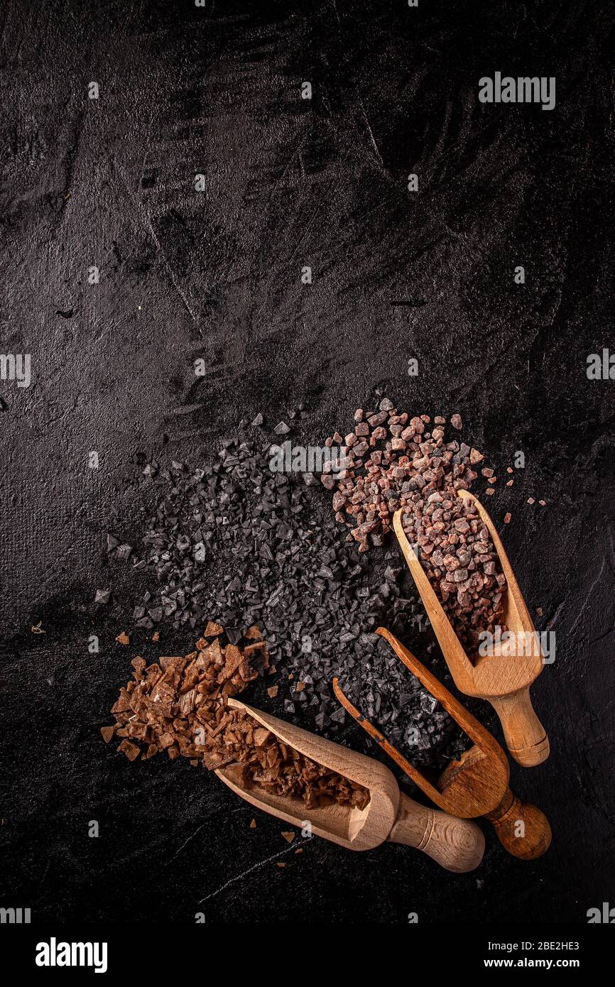 Mix of different salt types on black background, flat lay Stock Photo ...