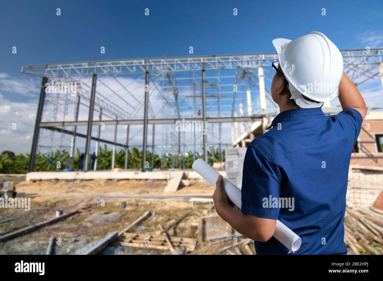 engineer holding blueprint with construction building background ...