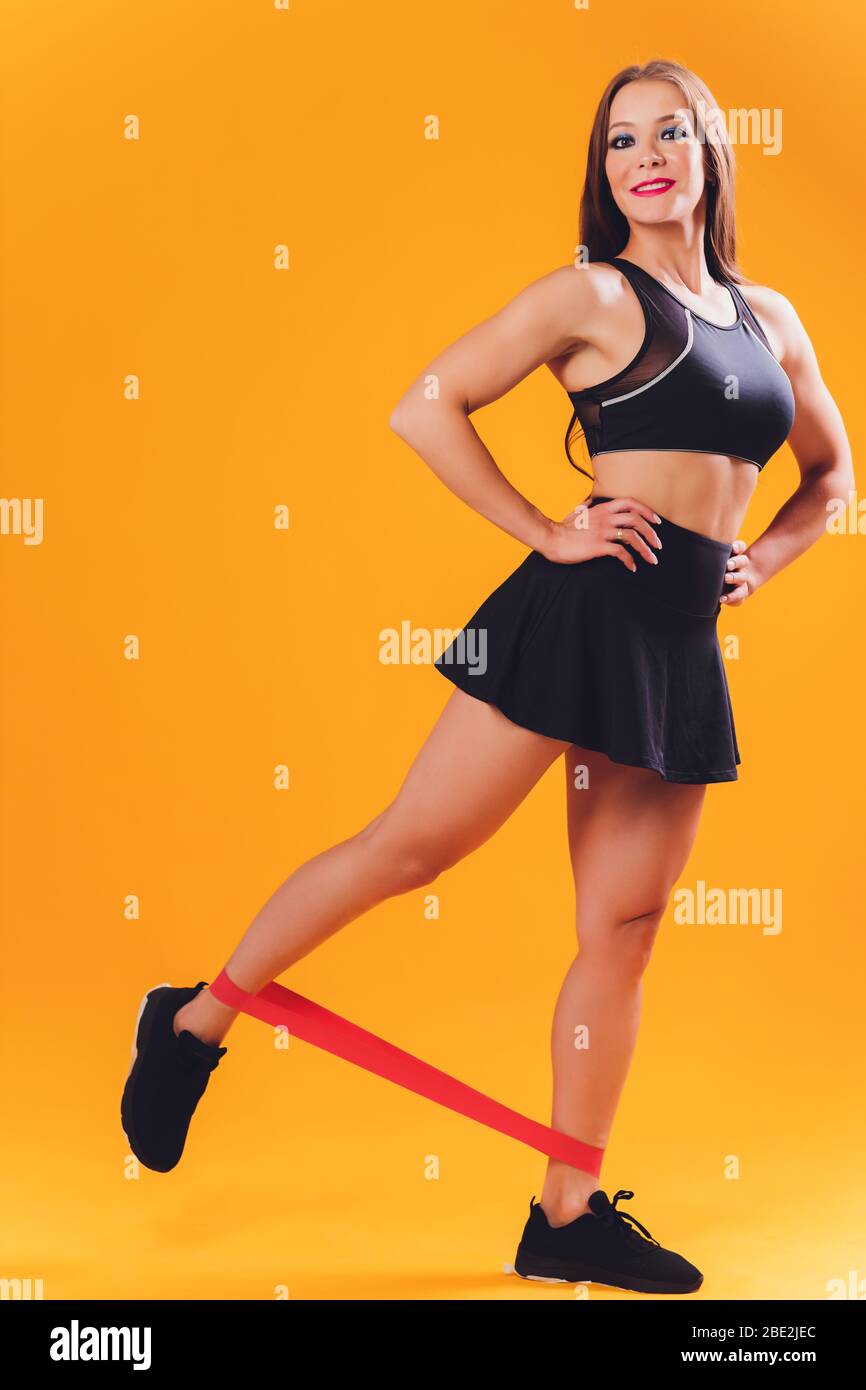 Athletic girl performs exercises using a resistance band. Photo of ...