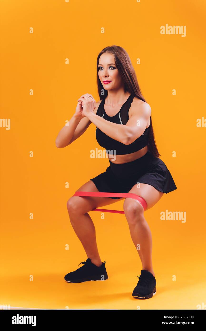 Athletic girl performs exercises using a resistance band. Photo of ...