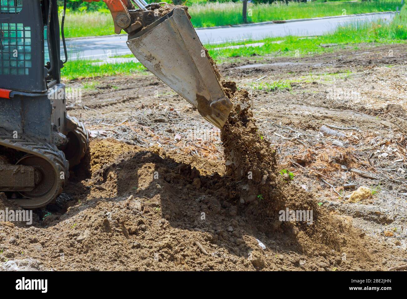 Small tractor digging land working with land level the ground Stock ...
