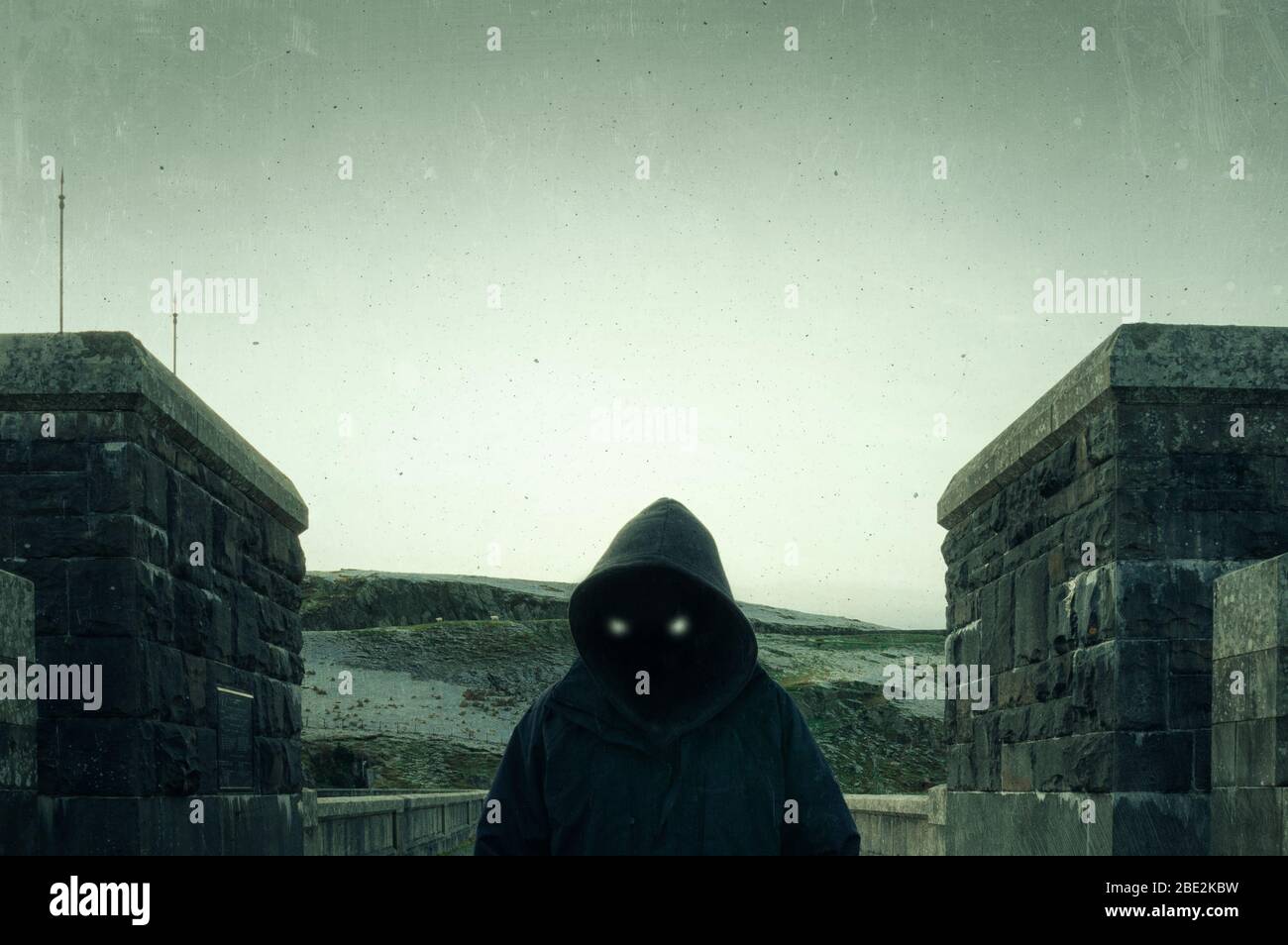 A scary, hooded figure with glowing evil eyes and blank black space ...