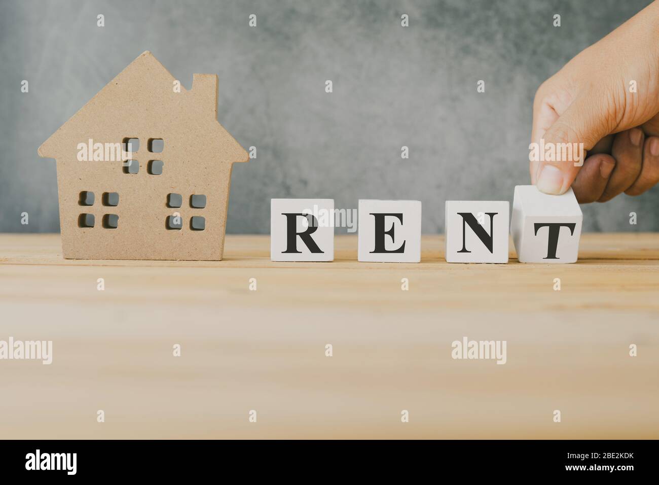 Renting home concept, hand holding rent words on wood block ...
