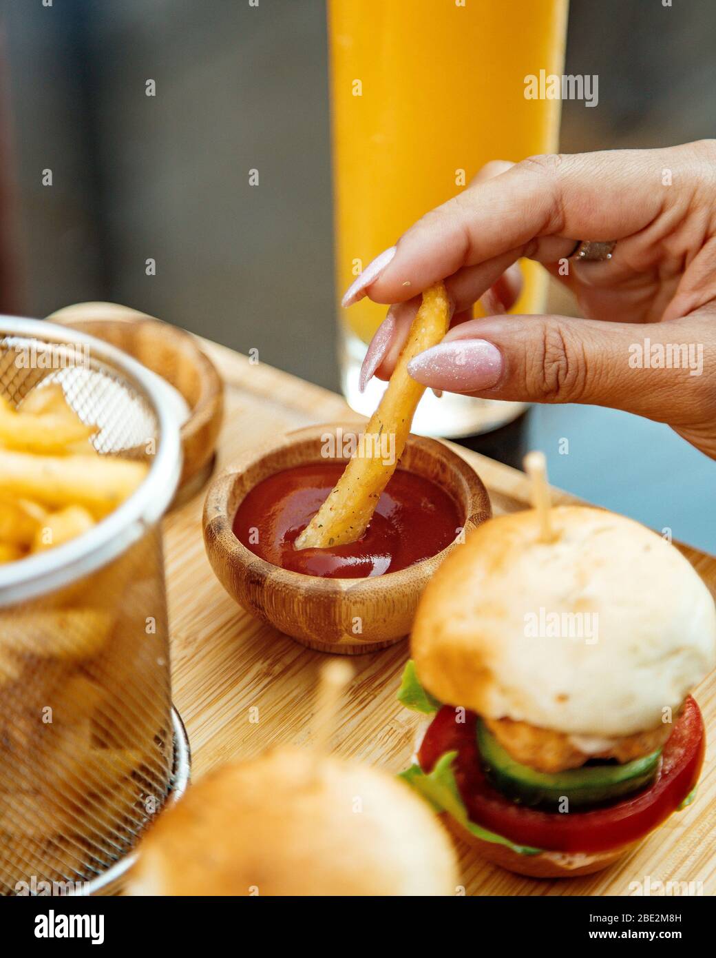 woman dipping french fries into ketchup Stock Photo - Alamy