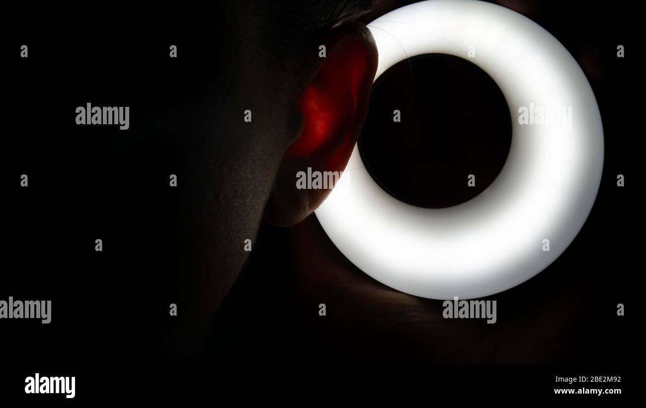 Abstract - The human ear with the dark LED light ring Stock Photo - Alamy