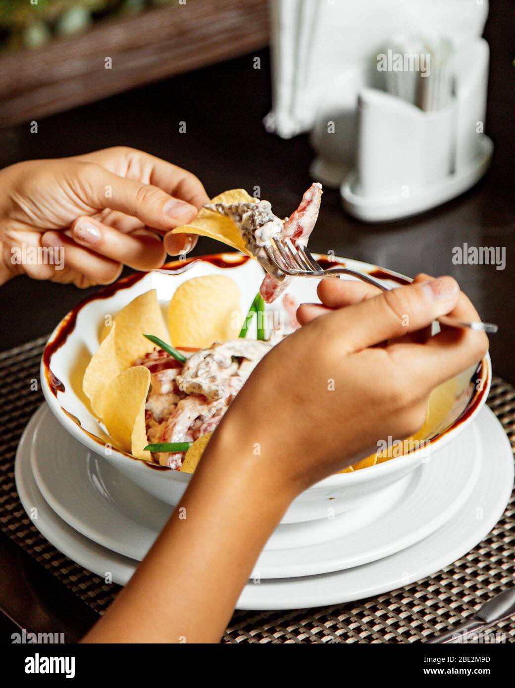 woman eating meat salad in mayonnaise with chips Stock Photo - Alamy