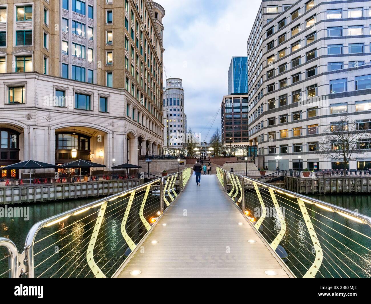 India place and Cabot square united by a footpath bridge illuminated at ...
