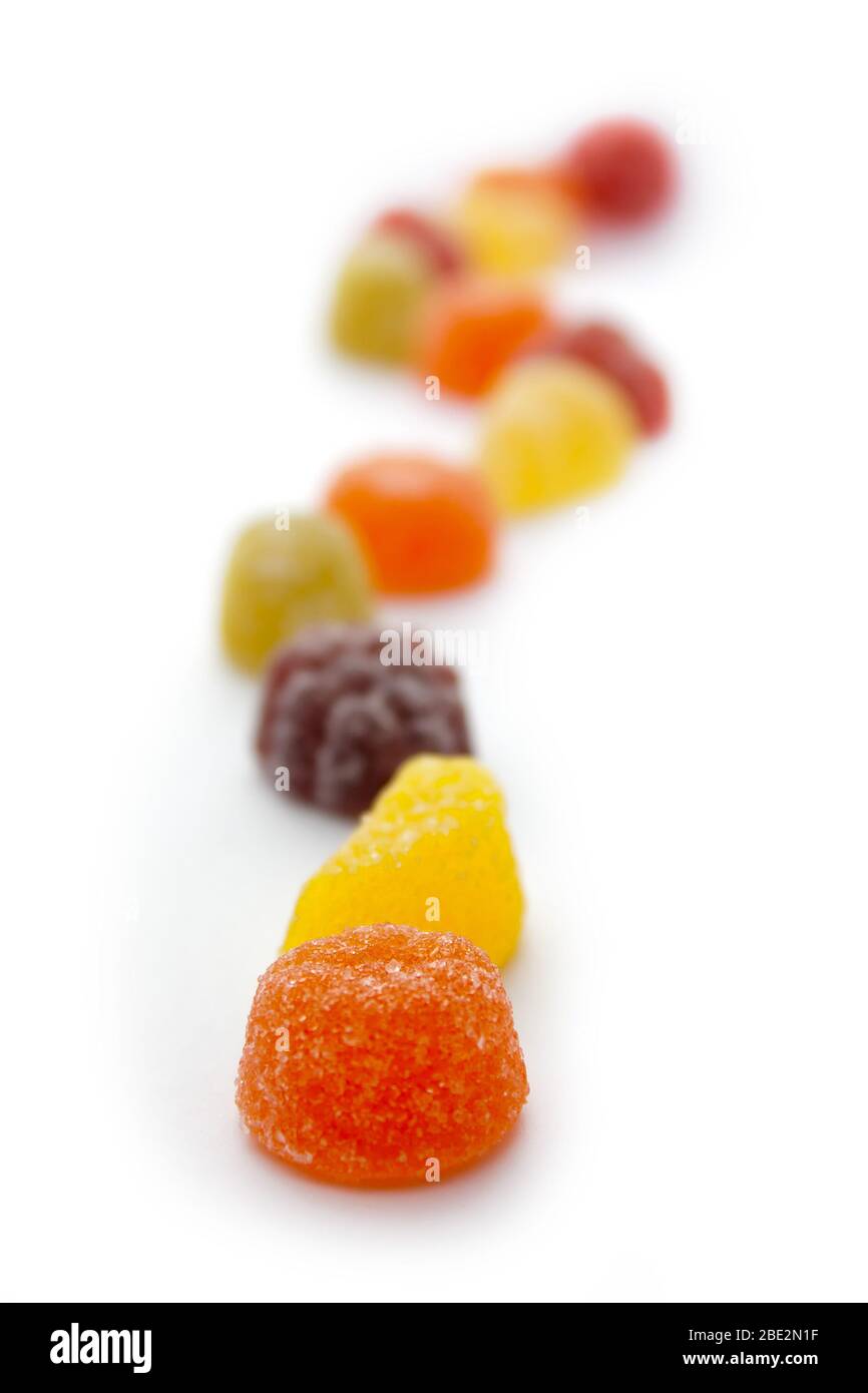 Fruit pastille sweets with a very shallow depth of field on a white ...