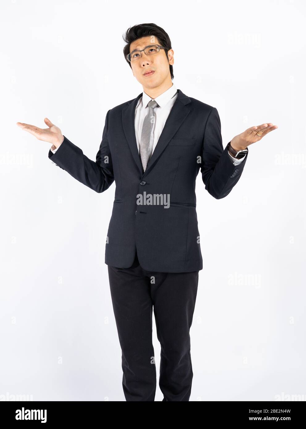 Smart businessman confused and surprised against white wall in studio ...