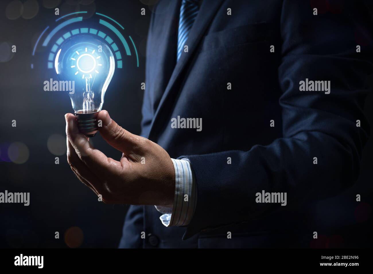 Innovation and energy of creative thinking, businessman holding light ...