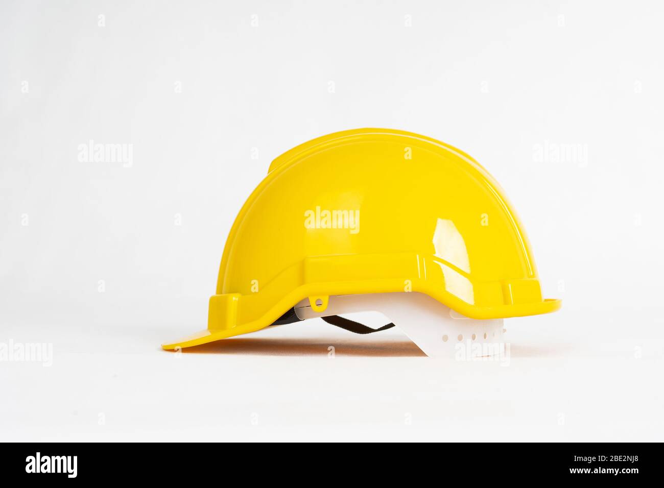 yellow construction helmet isolated on white background Stock Photo - Alamy