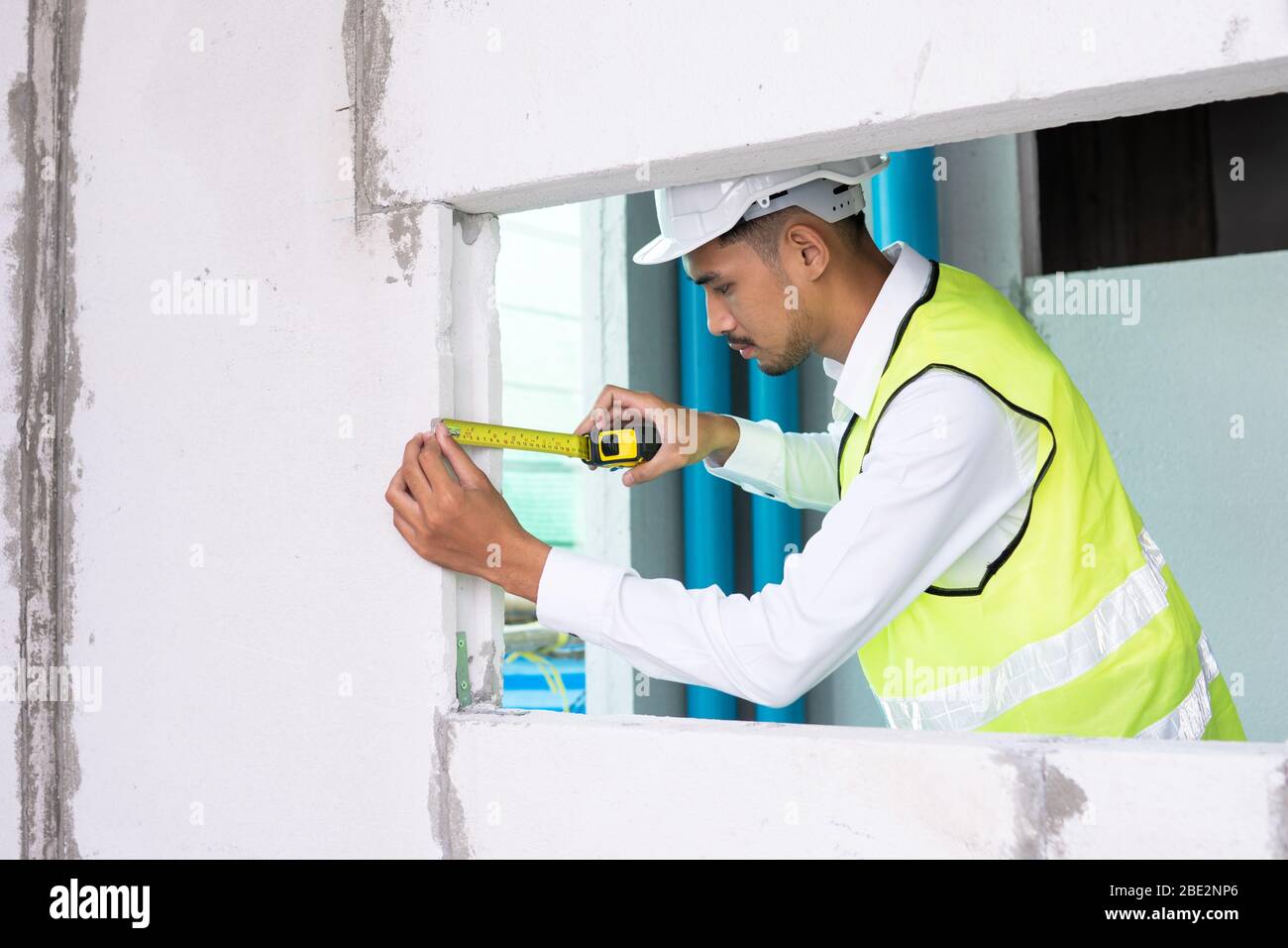 Inspector holding clipboard opening paper and checking building for ...