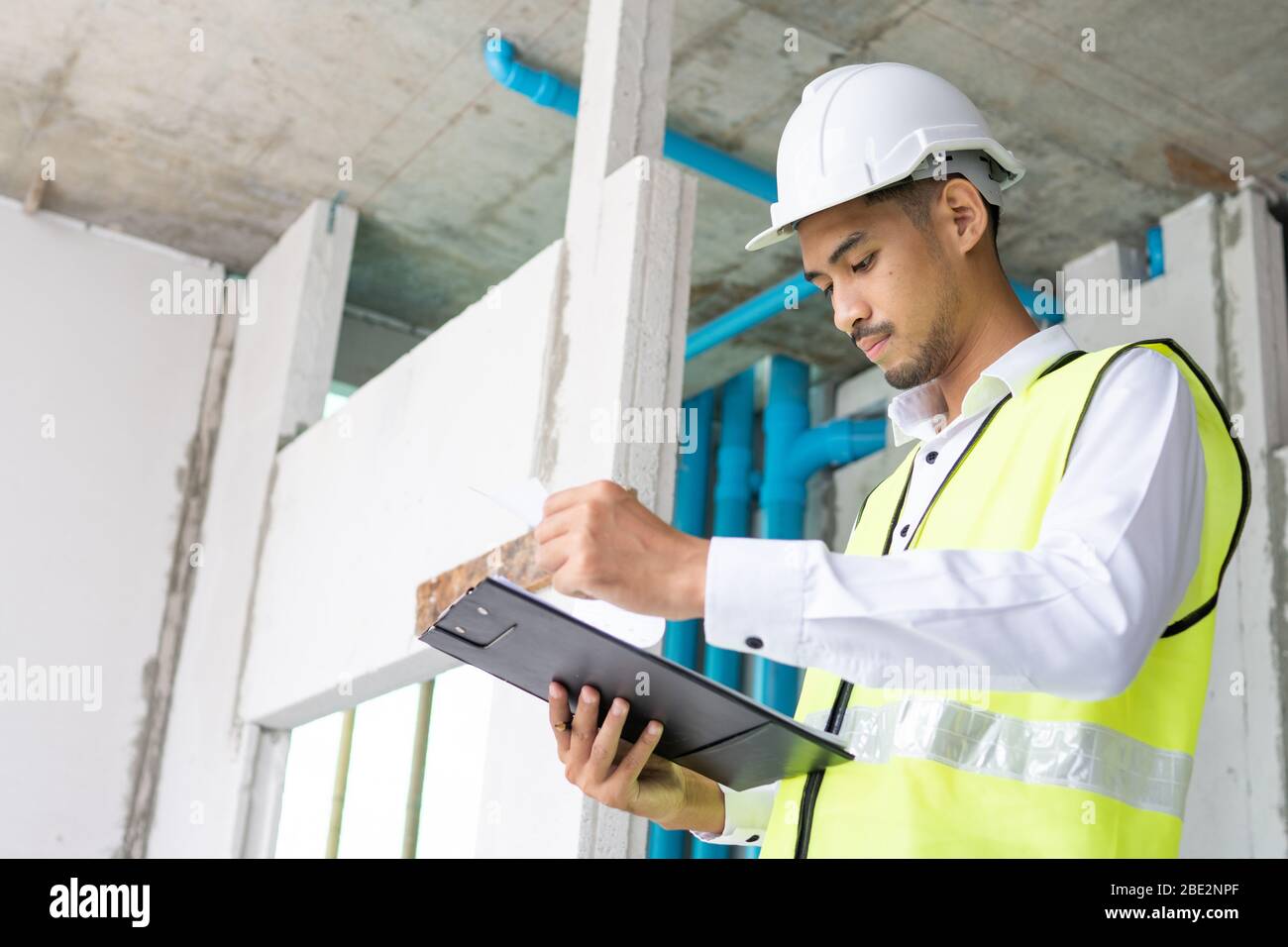 inspector open and checking infomation paper of construction materials ...