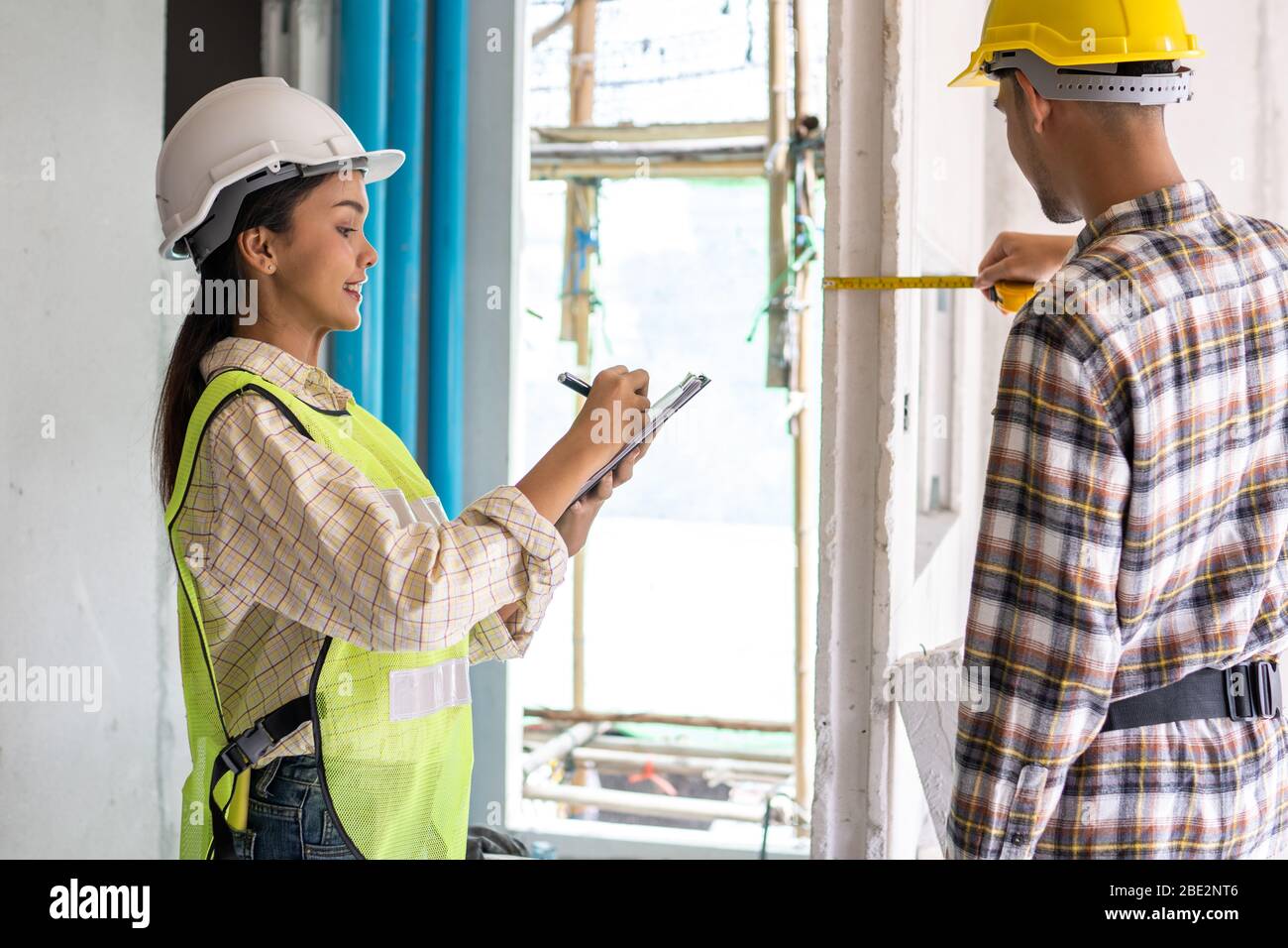 inspector checking and measure by measuring tape with assistant in ...